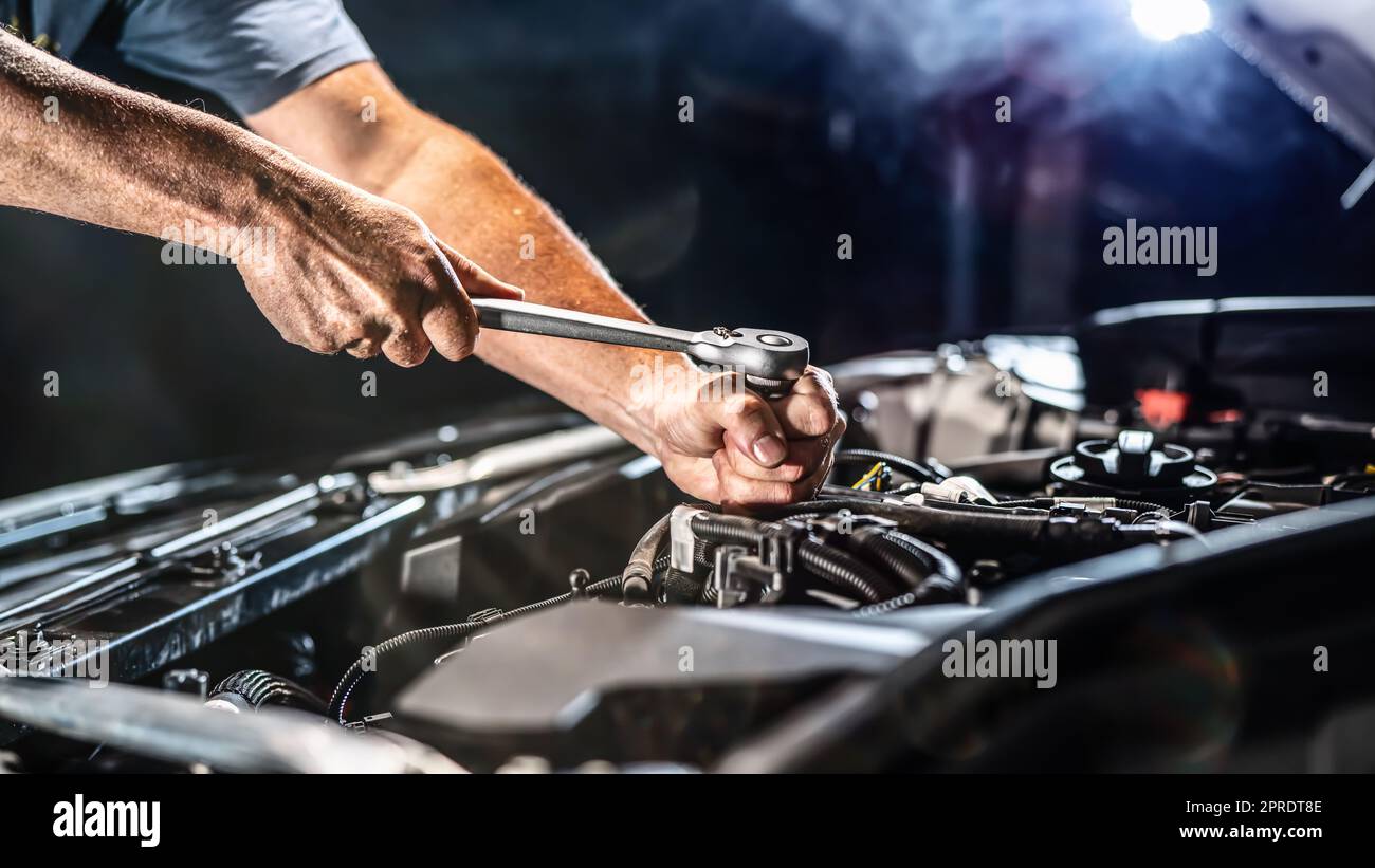 Auto mechanic working in garage. Repair service Stock Photo - Alamy
