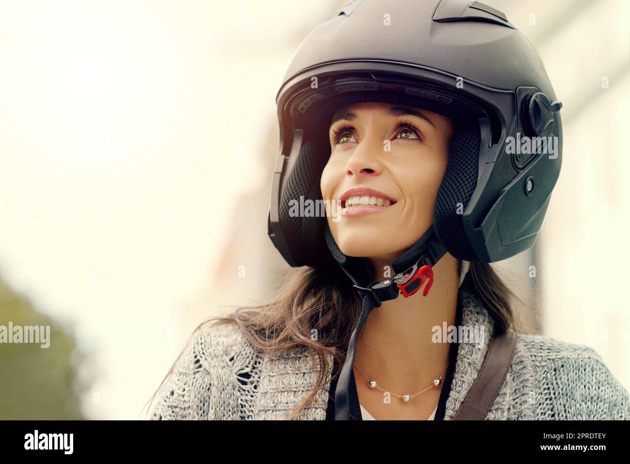 Smiling young woman wearing helmet hi-res stock photography and images ...