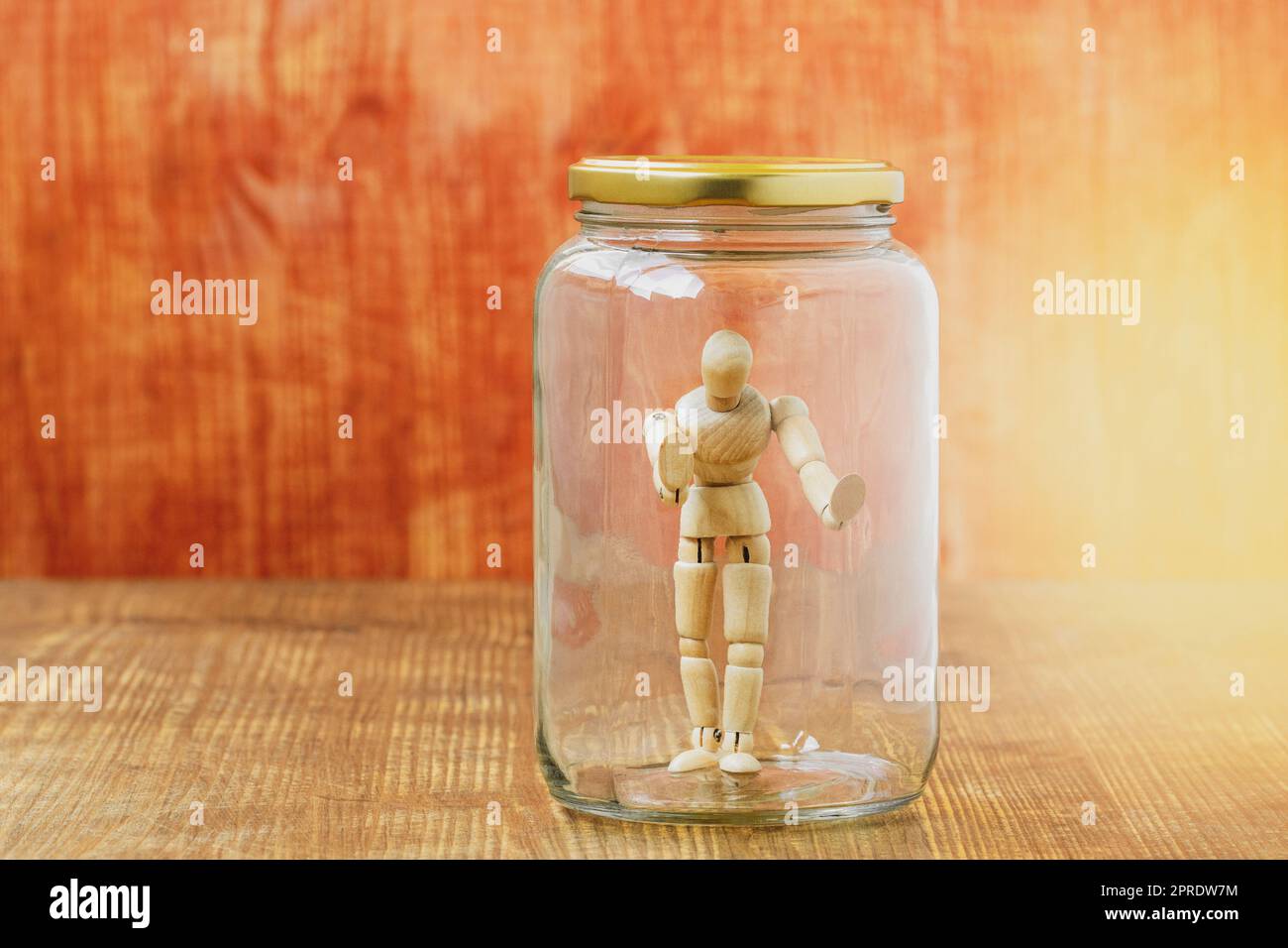 Dummy standing alone inside glass jar Stock Photo - Alamy