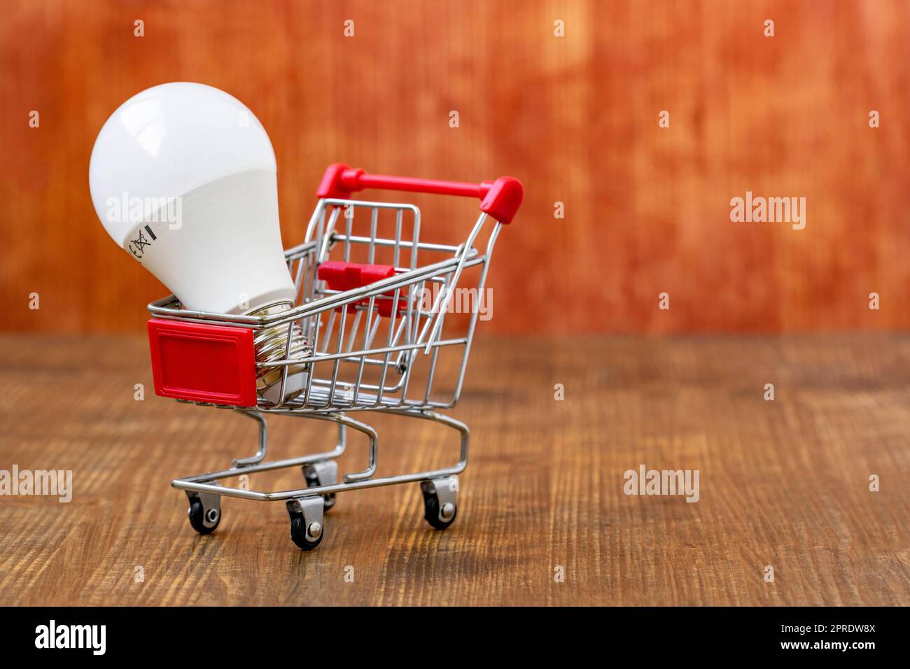 White light bulb in small shopping trolley Stock Photo - Alamy