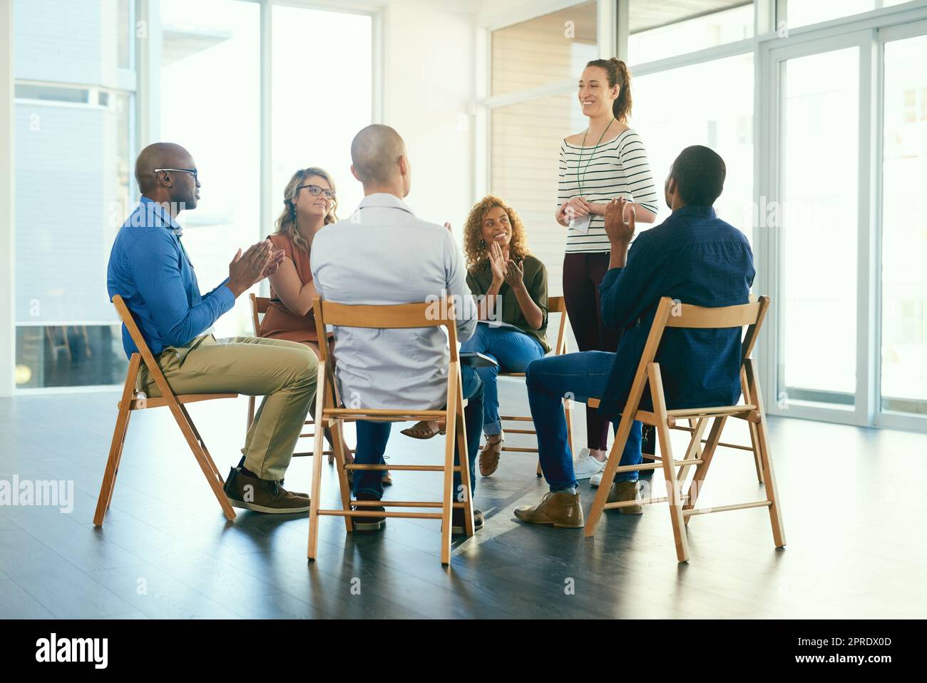 Business woman coaching a teamwork seminar at work about job motivation ...