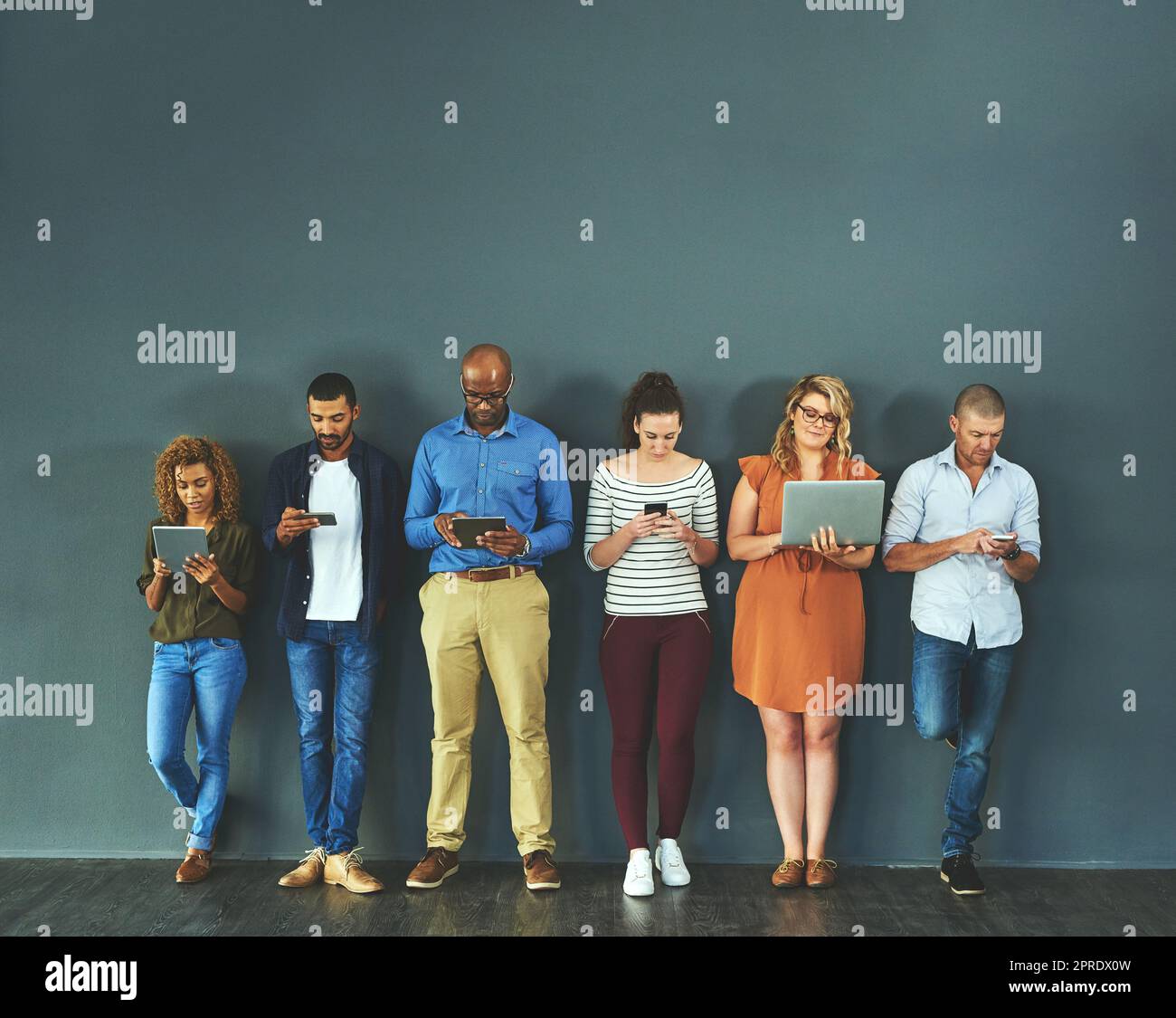 Diverse group of people browsing social media on a phone, tablet and ...