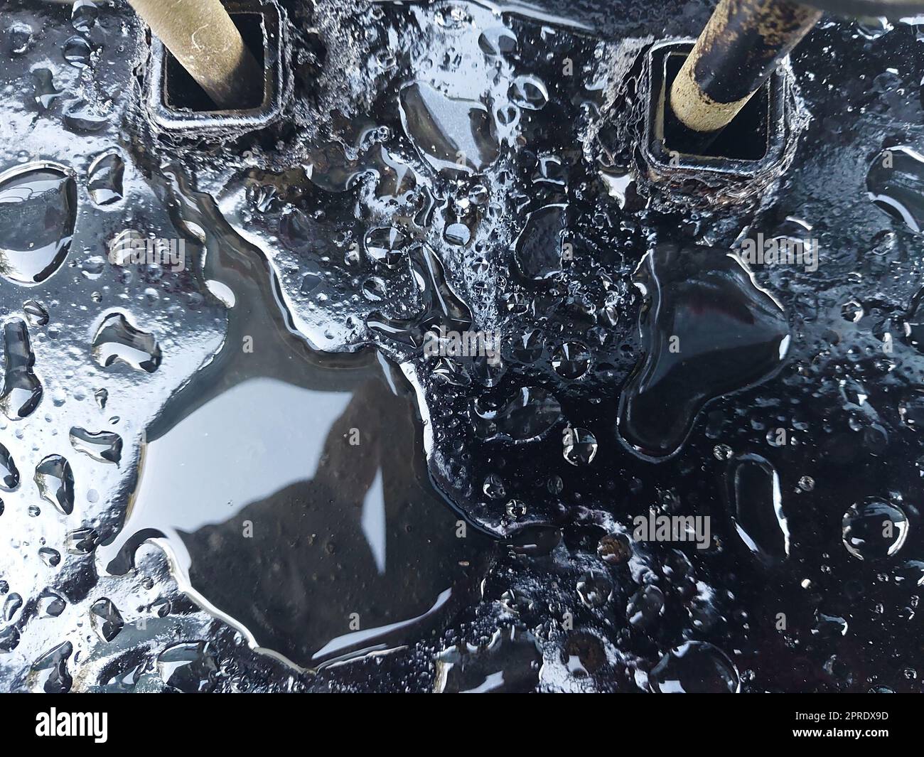 Spraying liquid bituminous mastic on the concrete foundation for the ...