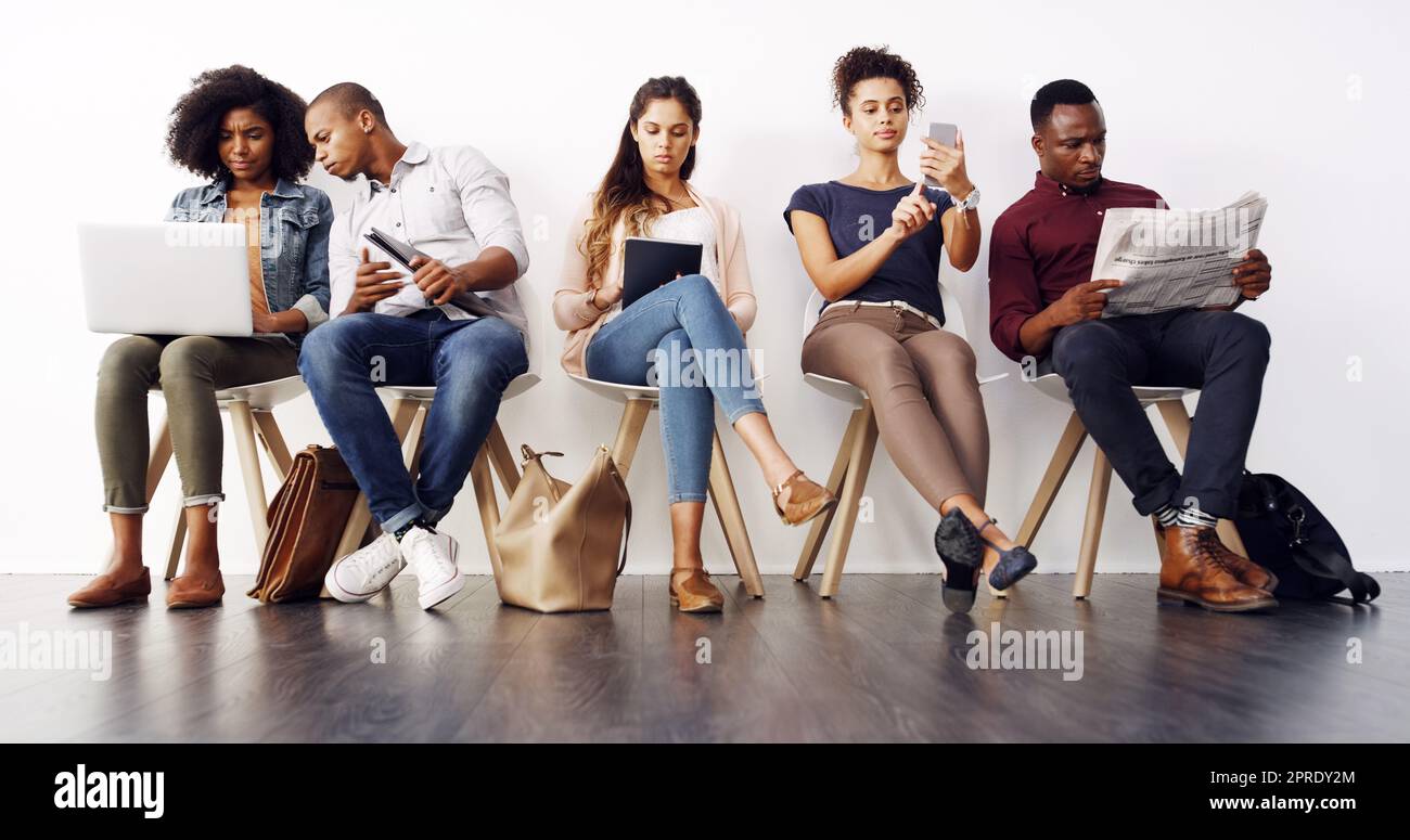 Preparing with some research. a group of diverse businesspeople waiting ...