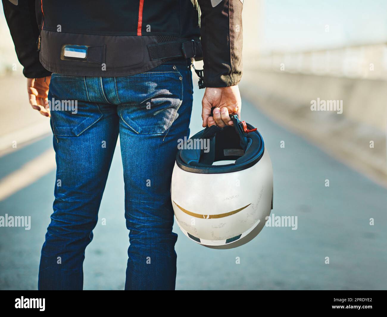 Grab your helmet and hit the road. a young man riding a motorbike ...
