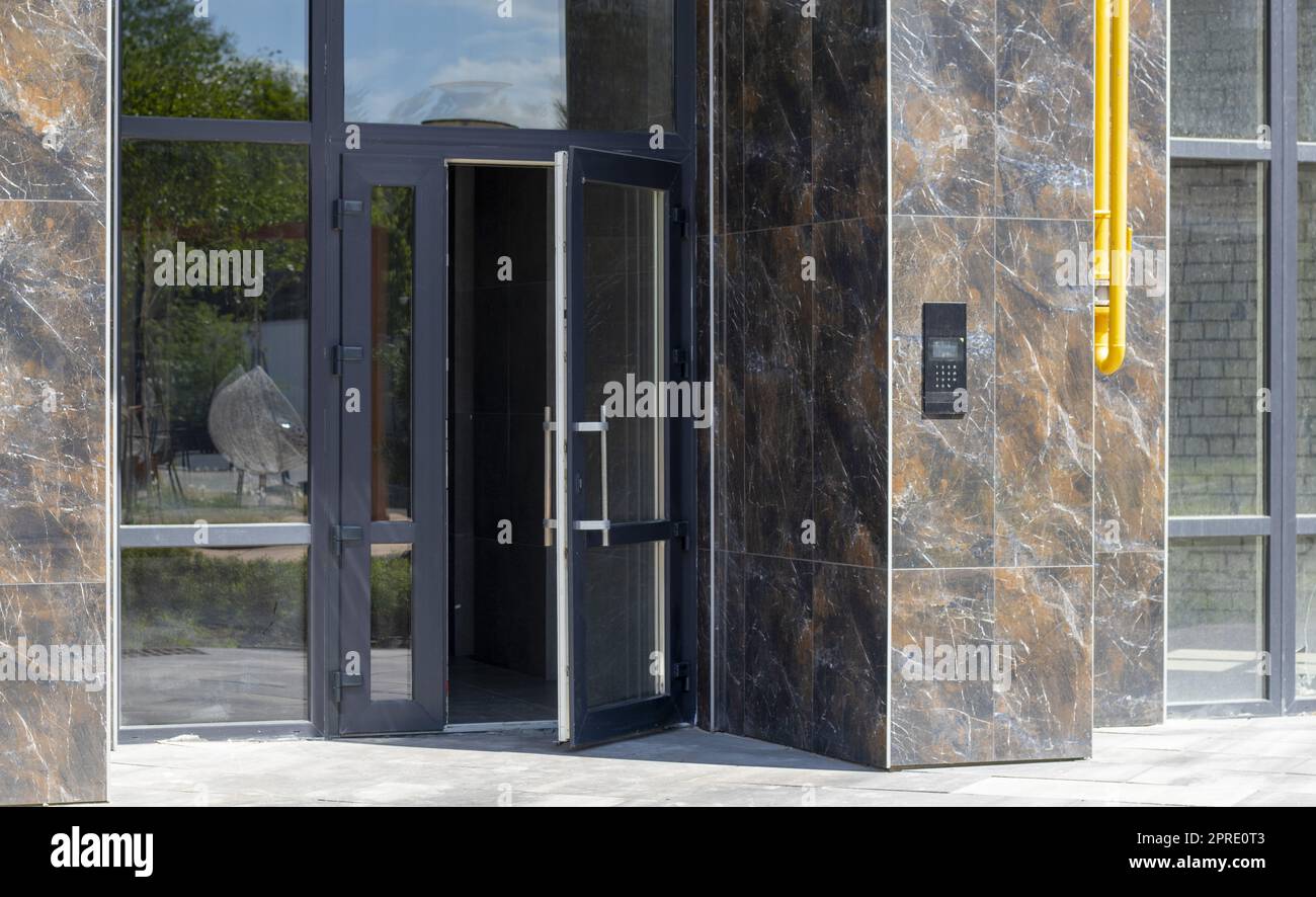 Facade of commercial premises with panoramic windows at street level in ...