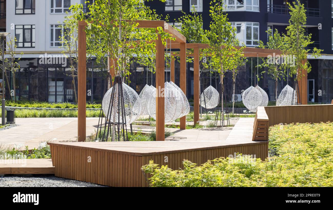 A cozy seating area in the courtyard of a modern residential complex ...