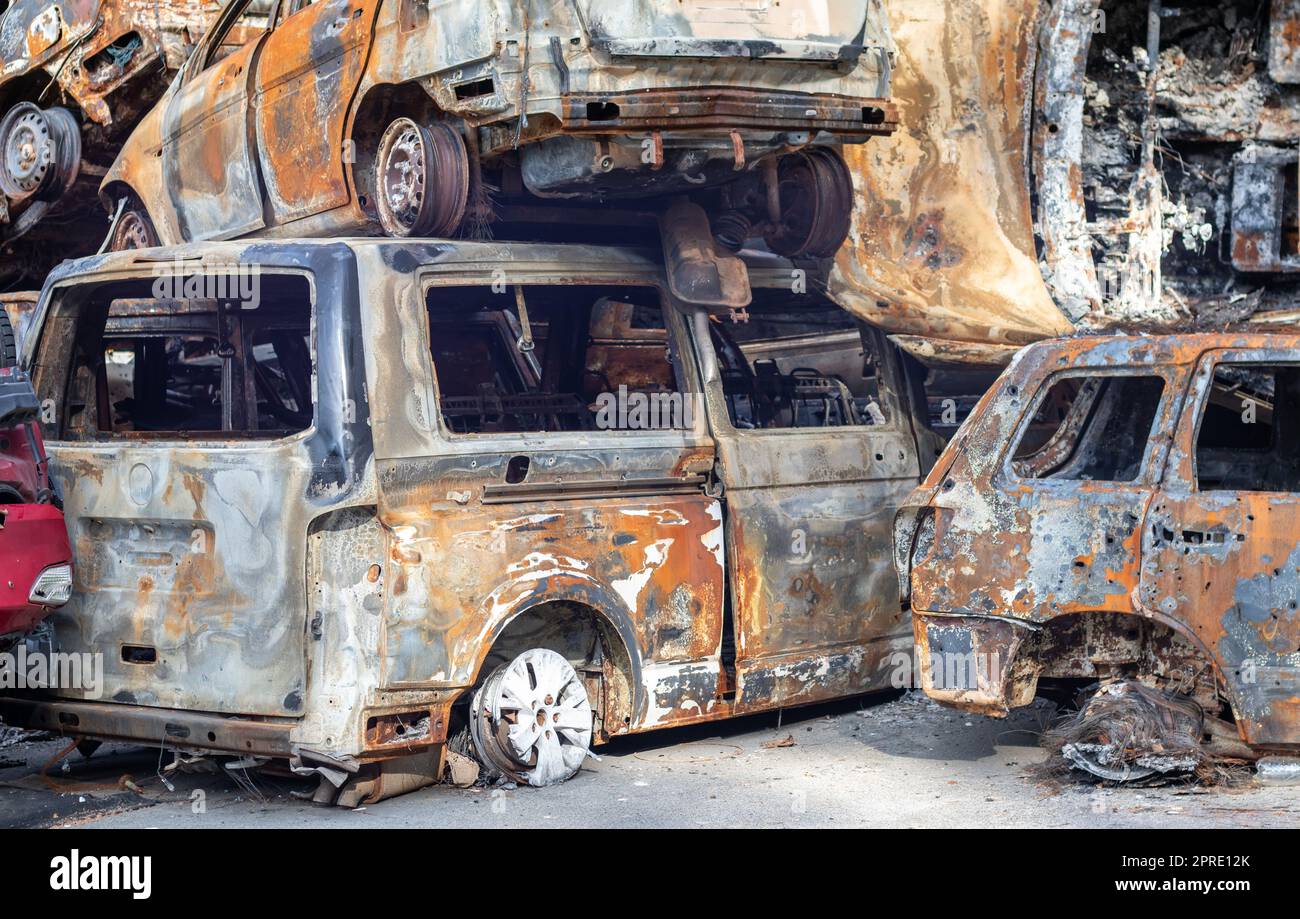 Rusty burnt cars destroyed by rocket explosions. War in Ukraine ...