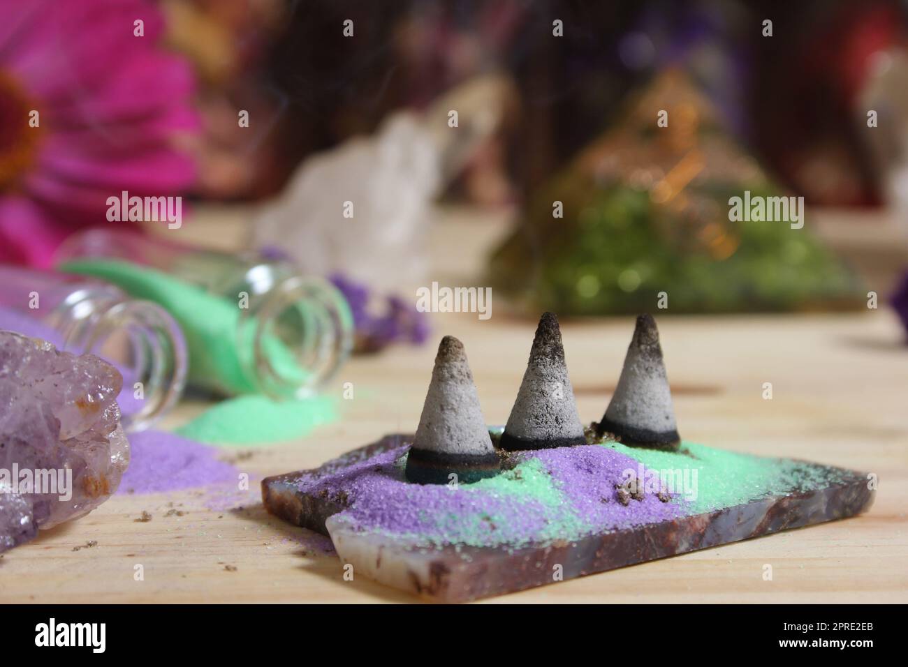 Incense Cones on Stone Slab With Crystals and Flowers Stock Photo - Alamy