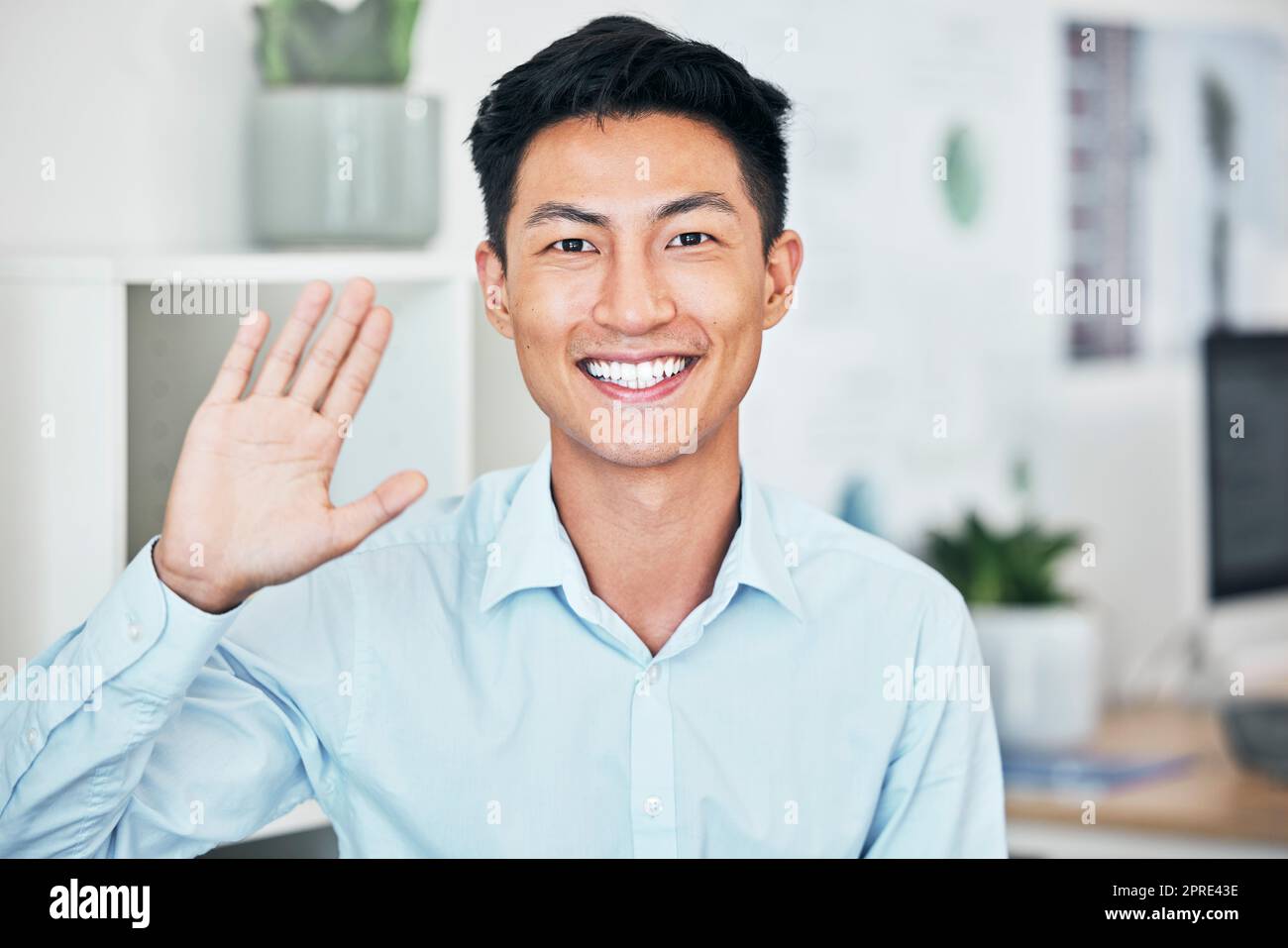Happy business man greeting, waving and saying hello with hand gesture ...