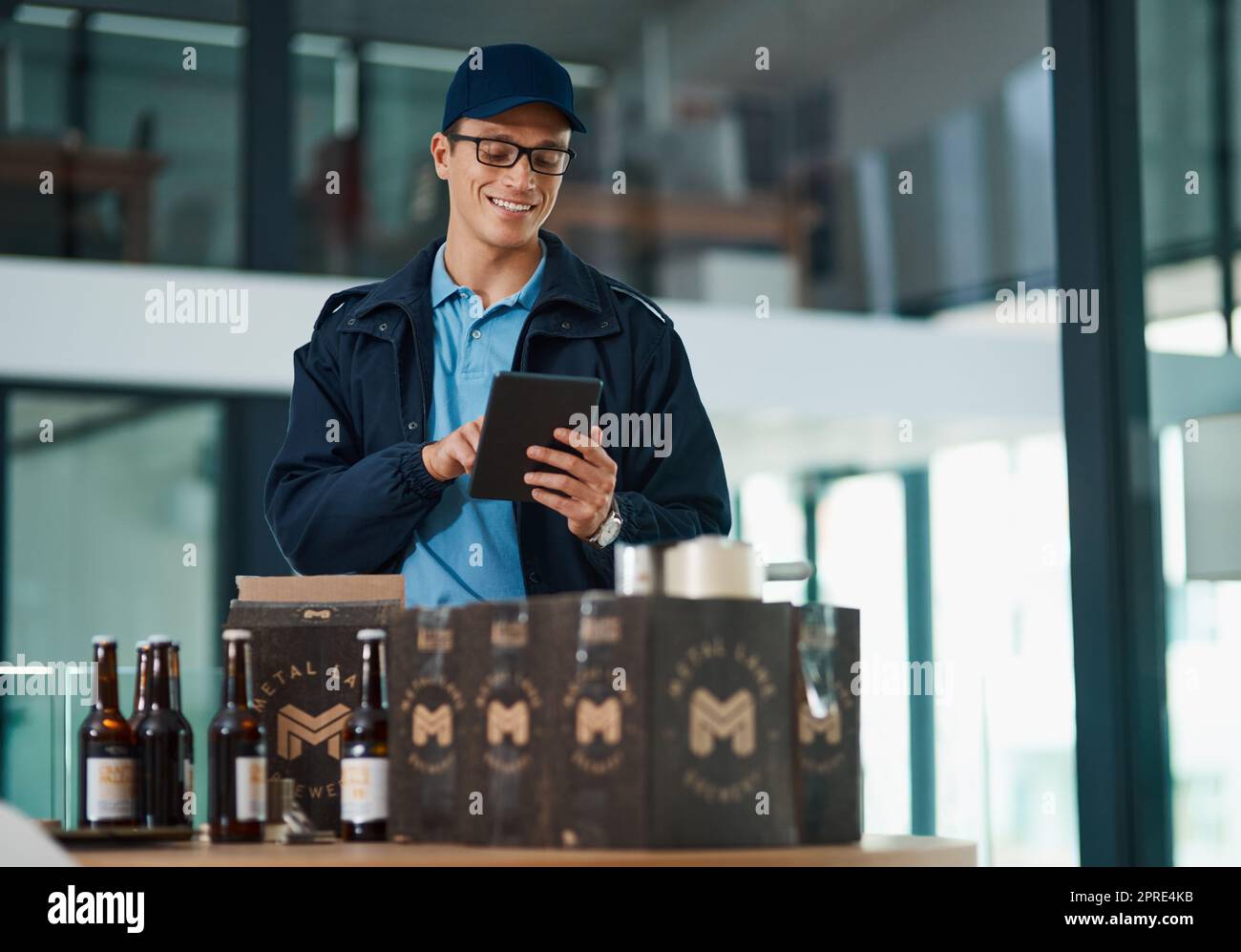 Stock taking on my device. a handsome young man taking inventory of ...