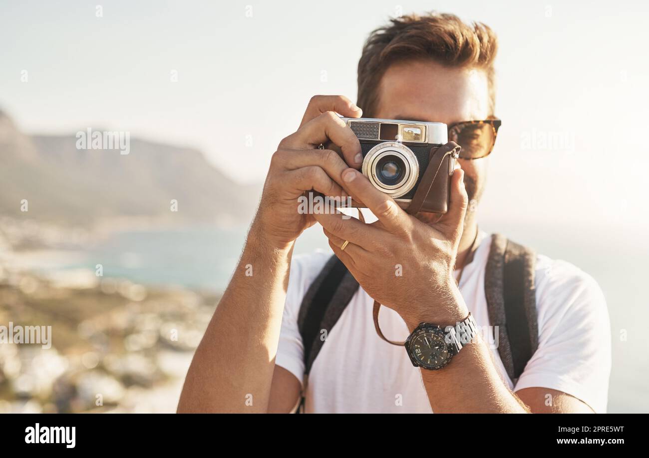 Smile. Cropped portrait of a handsome young man taking photographs ...