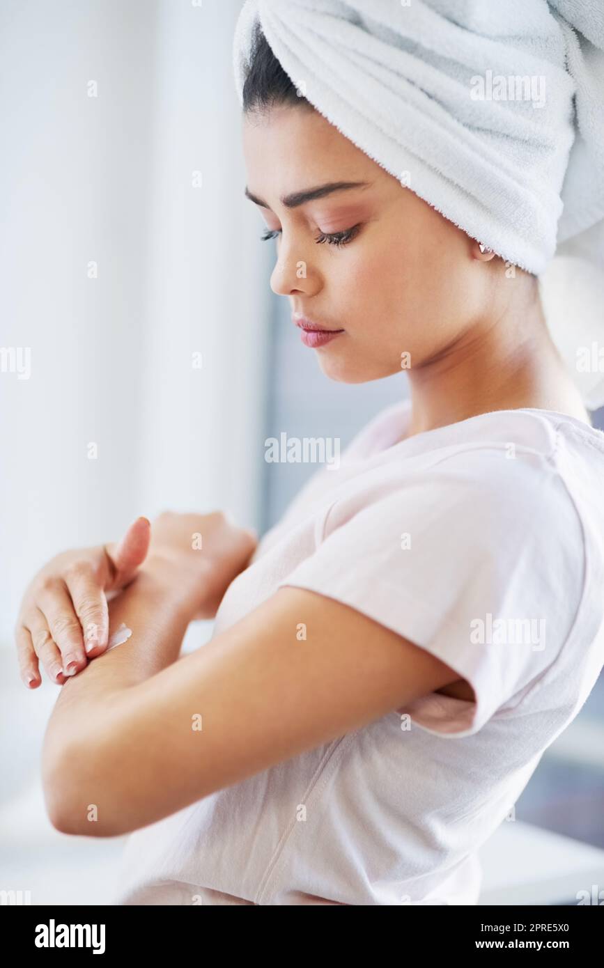 No sign of dry arms or elbows here. a beautiful young woman applying ...