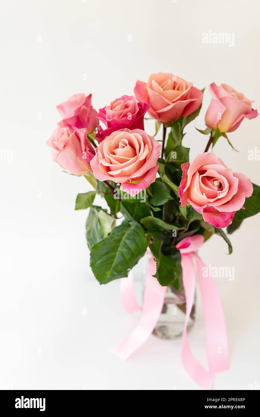 Beautiful bright pink-red roses, flowers in a vase, side view, vertical ...