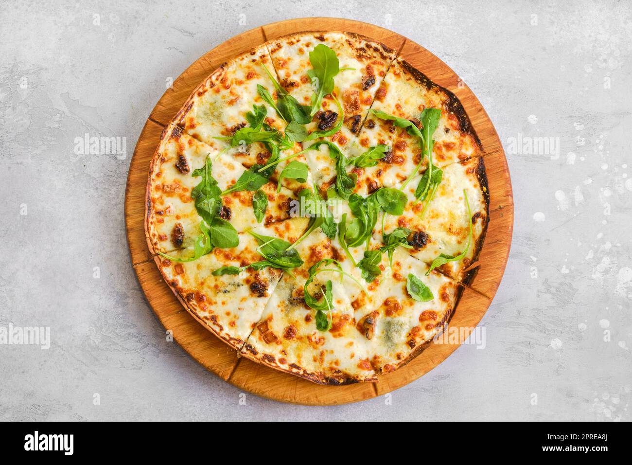 Top view of thin-crust pizza dough with walnuts, truffle oil and maple ...
