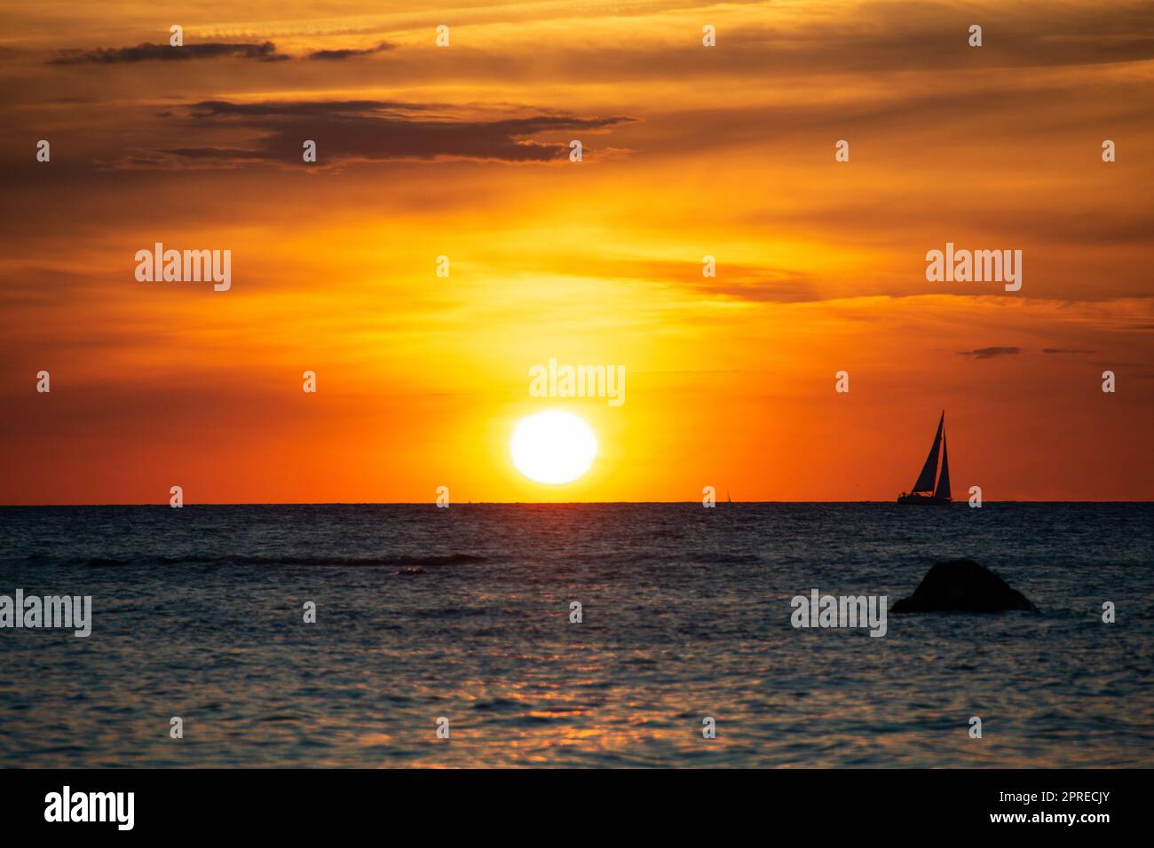 Beautiful orange sunset over the sea, a ship on the horizon Stock Photo ...