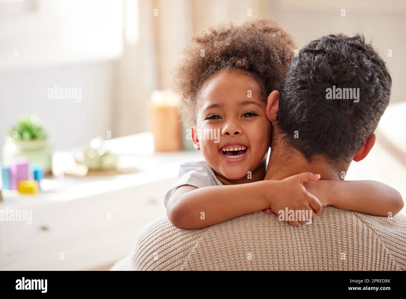 Adorable little mixed race girl with curly afro hair smiling and ...