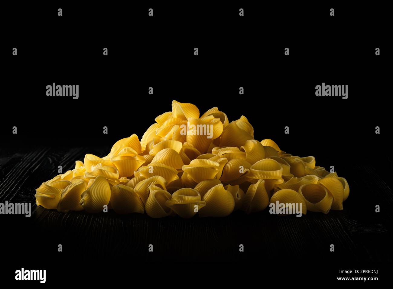 Low key photo of pipe rigate pasta. Organic whole wheat grooved pipes ...