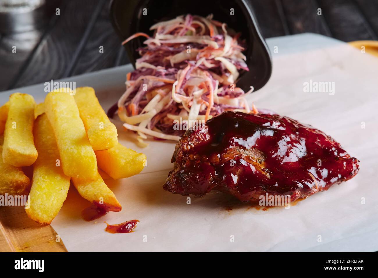 Rustic lunch. Grilled ribs with fried potato and red cabbage salad ...