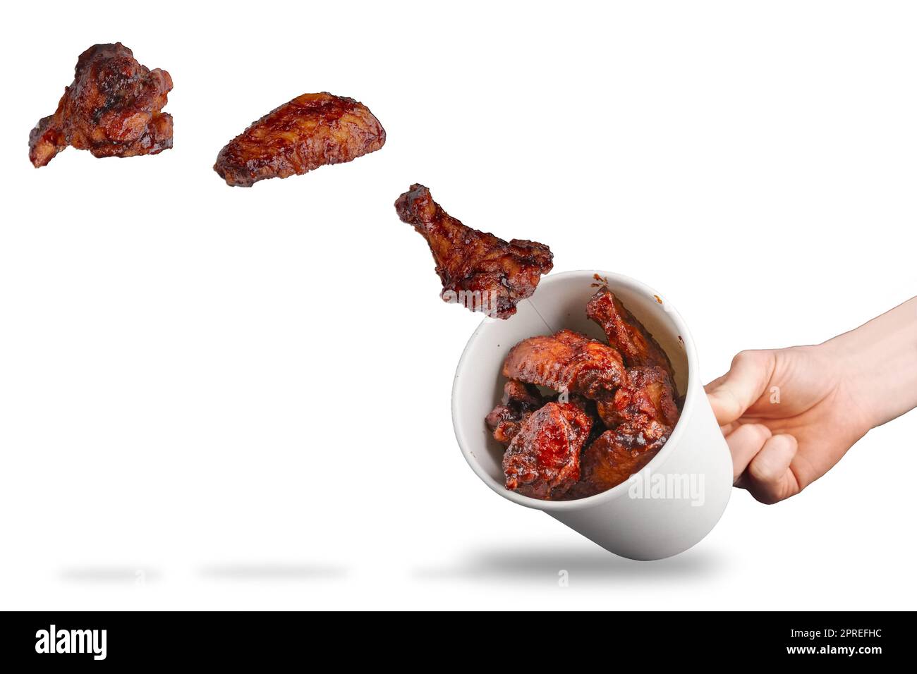 Catching flying fried chicken wings in cardboard container Stock Photo ...