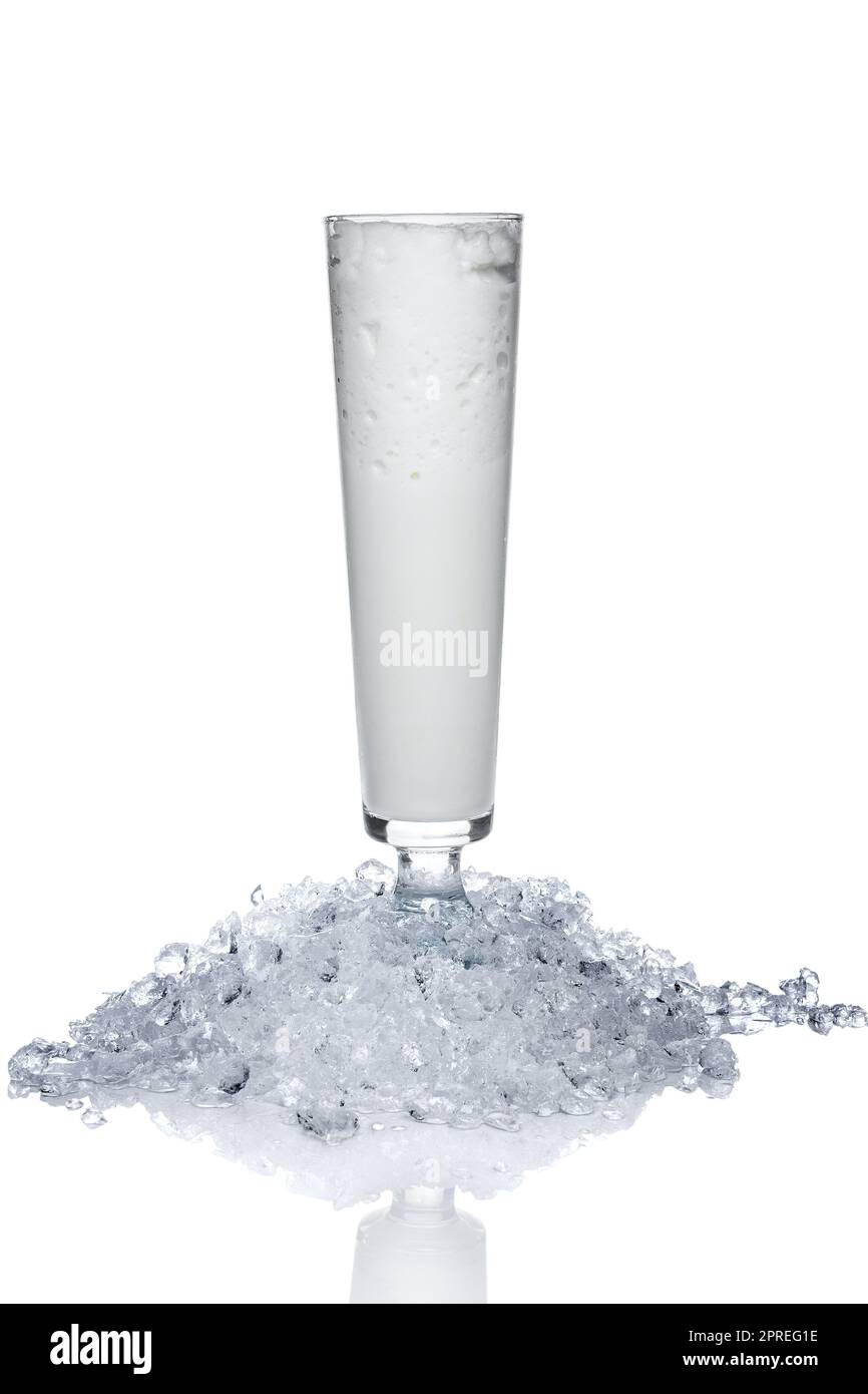 Sling glass with ice-cream and whipped cream on heap of crushed ice ...