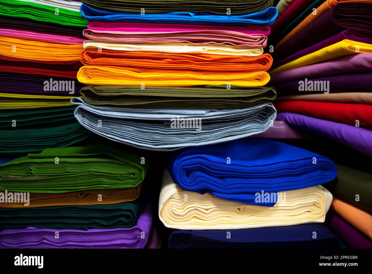 Artistic variety shade tone colors Textile Fabrics stacked on retail ...