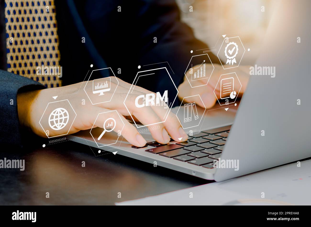 Hand typing on laptop concept. Icons CRM Customer Relationship Management business on virtual ...