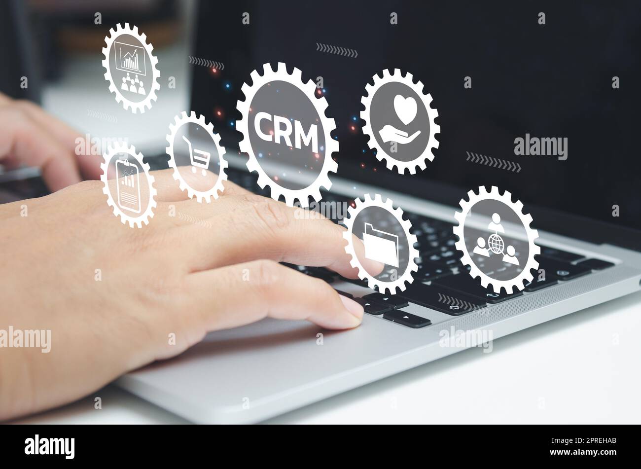 Hand typing on laptop concept. Icons CRM Customer Relationship Management business on virtual ...