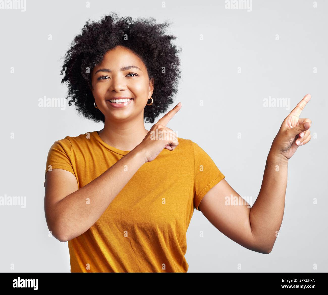 Portrait of happy woman, advertising and pointing to studio offer ...