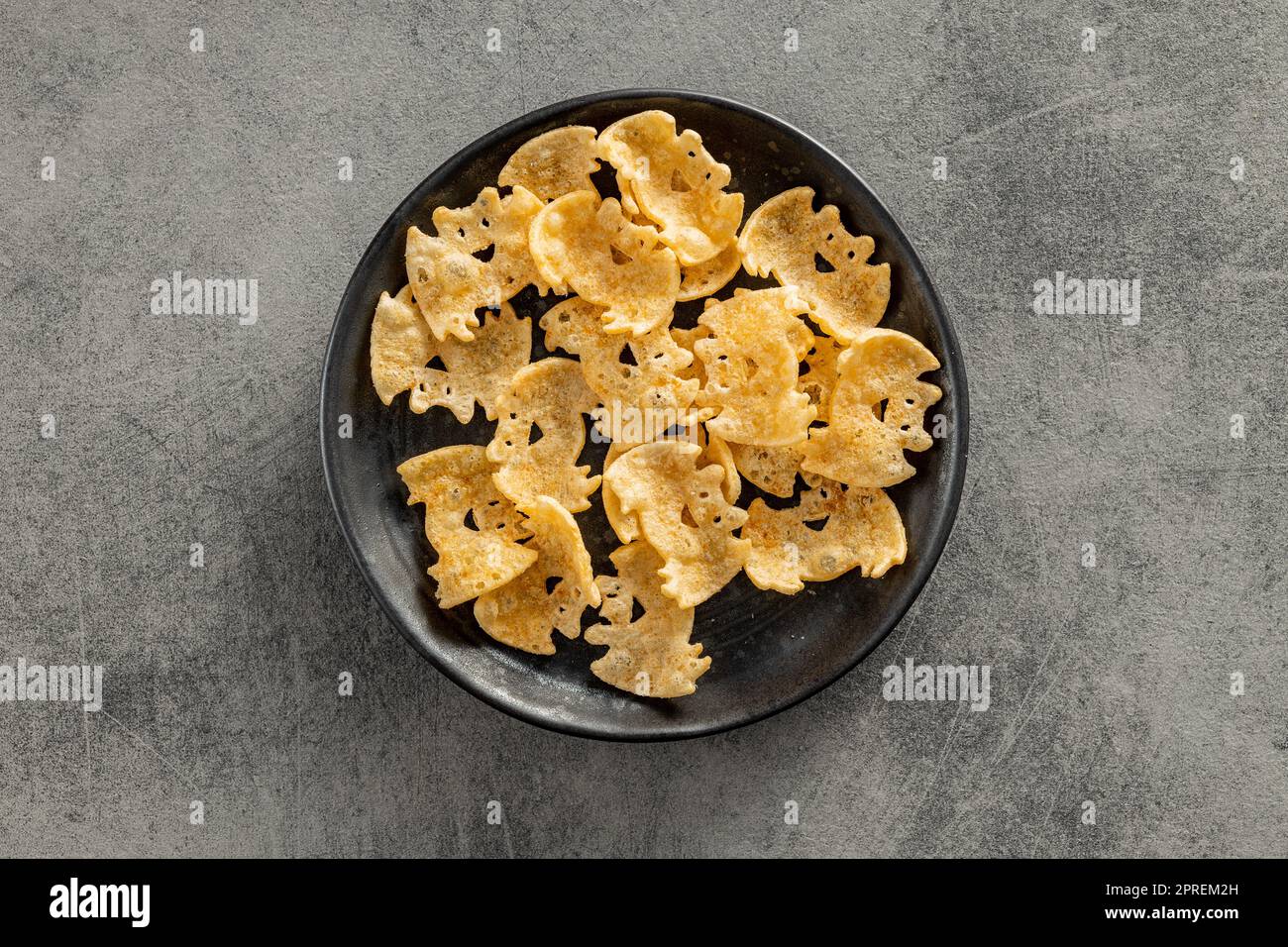 Halloween crispy bat shaped chips on the plate. Top view Stock Photo ...