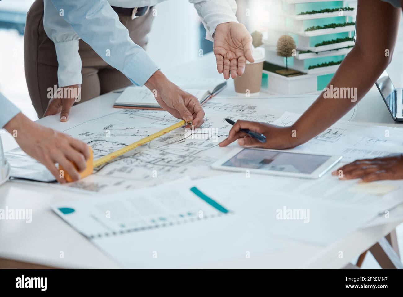 Blueprint, construction and architect team planning in meeting, drawing ...