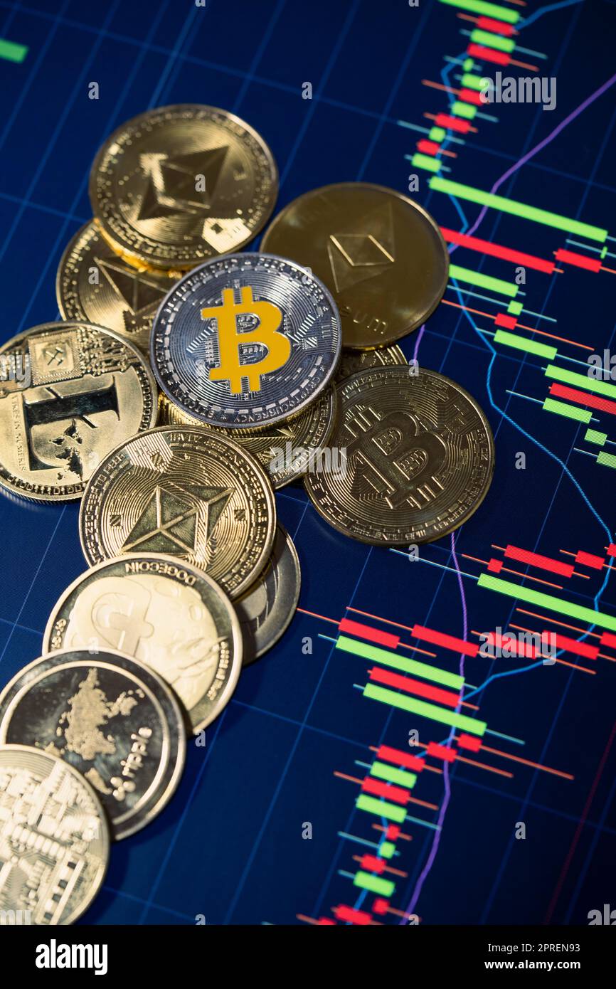 Stack or heap of gold various cryptocurrency coins with candle stick ...