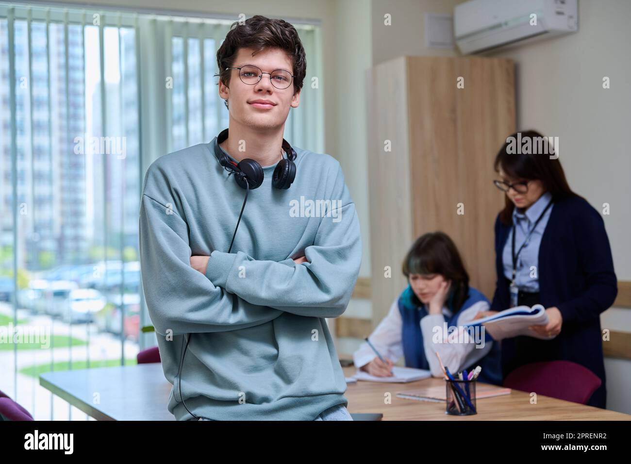 Portrait of college student guy looking at camera inside classroom ...