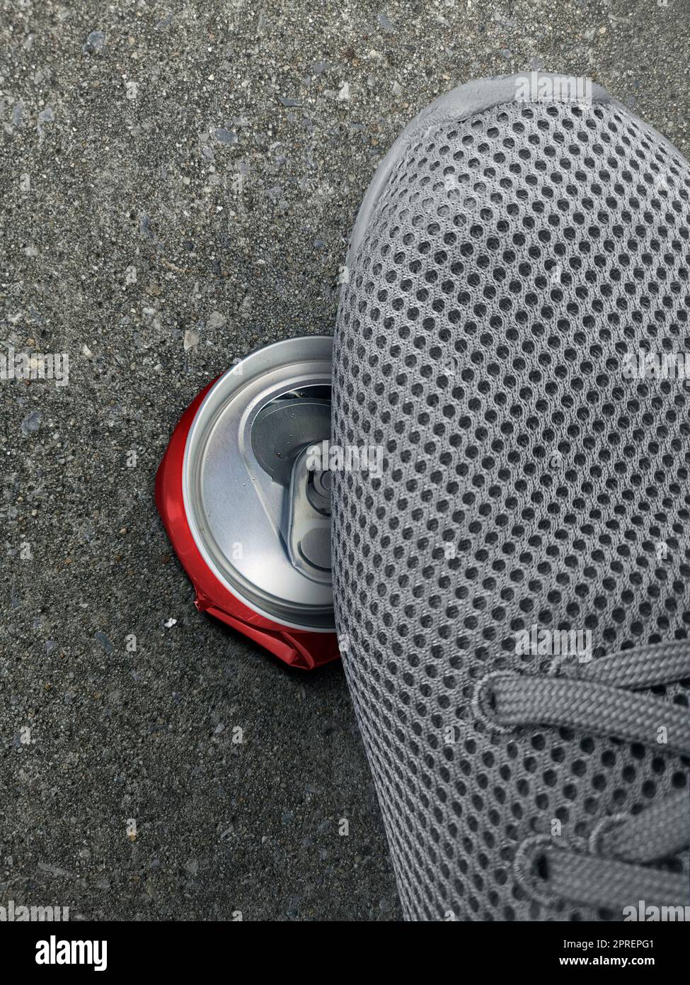 A man stepped stepping compressed cans on cement ground Stock Photo - Alamy