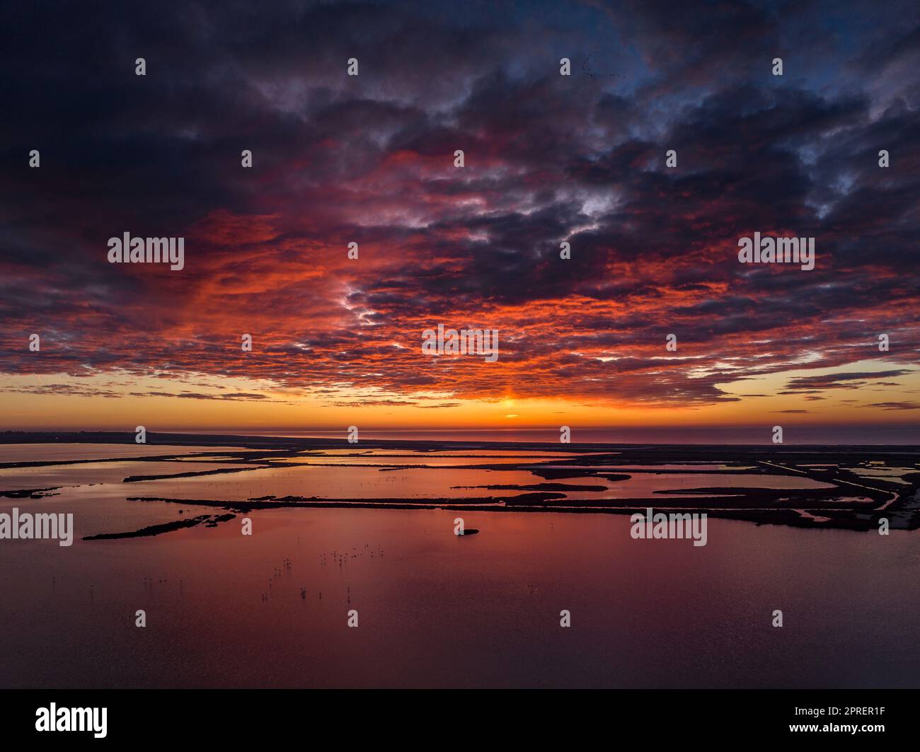 Aerial view of La Tancada lagoon at sunrise with a burning sky (Montsià ...