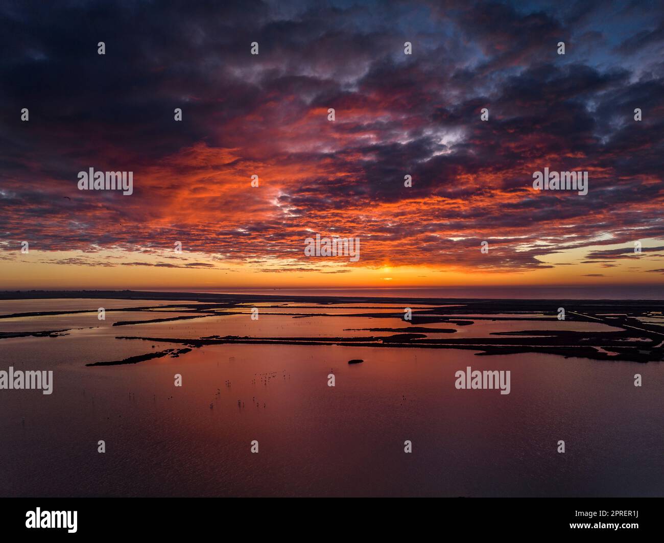 Aerial view of La Tancada lagoon at sunrise with a burning sky (Montsià ...