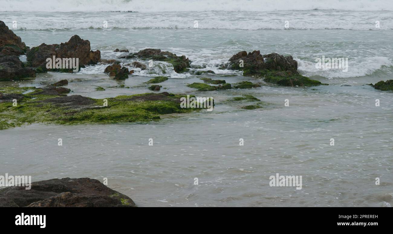 Sea wave splash on rock at beach Stock Photo - Alamy