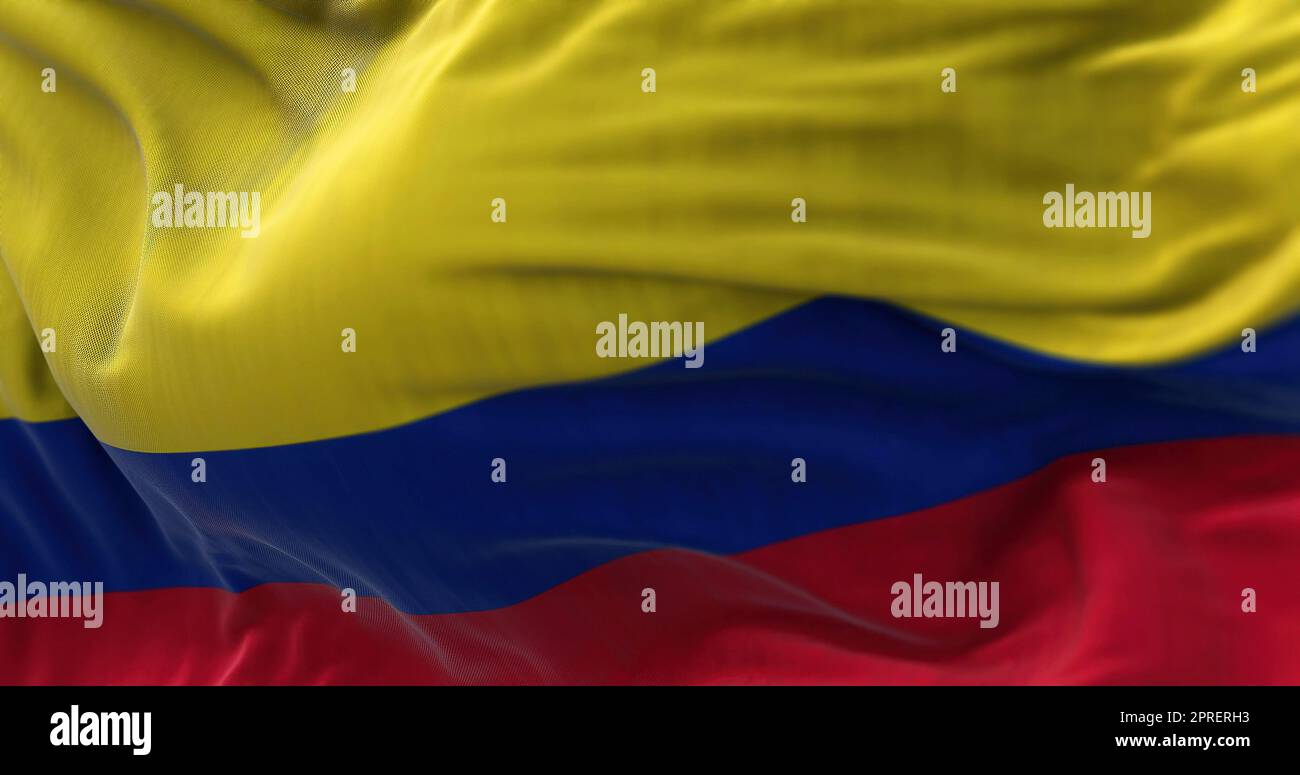 Close-up view of the Colombia national flag waving in the wind. The ...