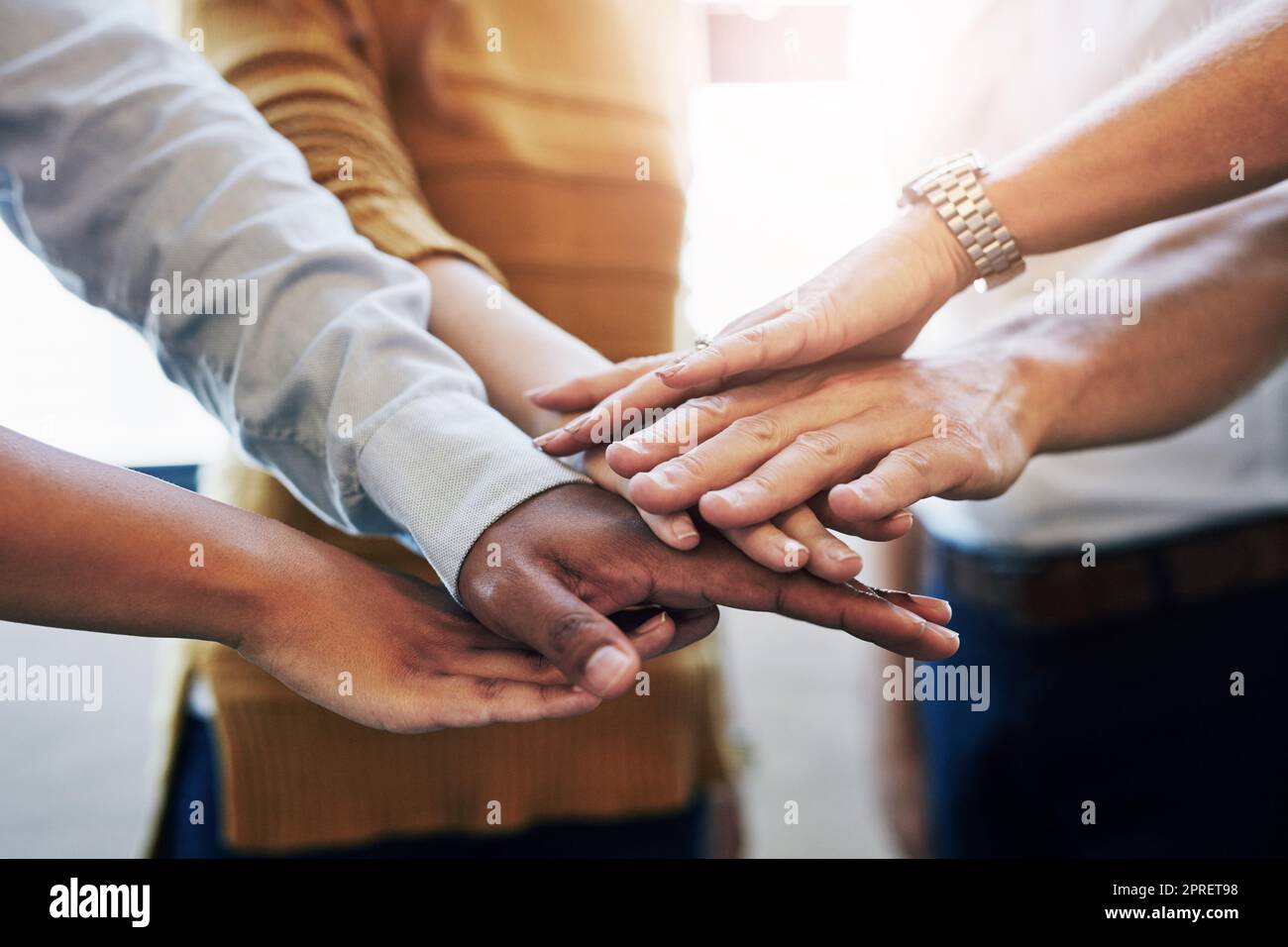 Teamwork, unity and collaboration by hands joining in support of a ...