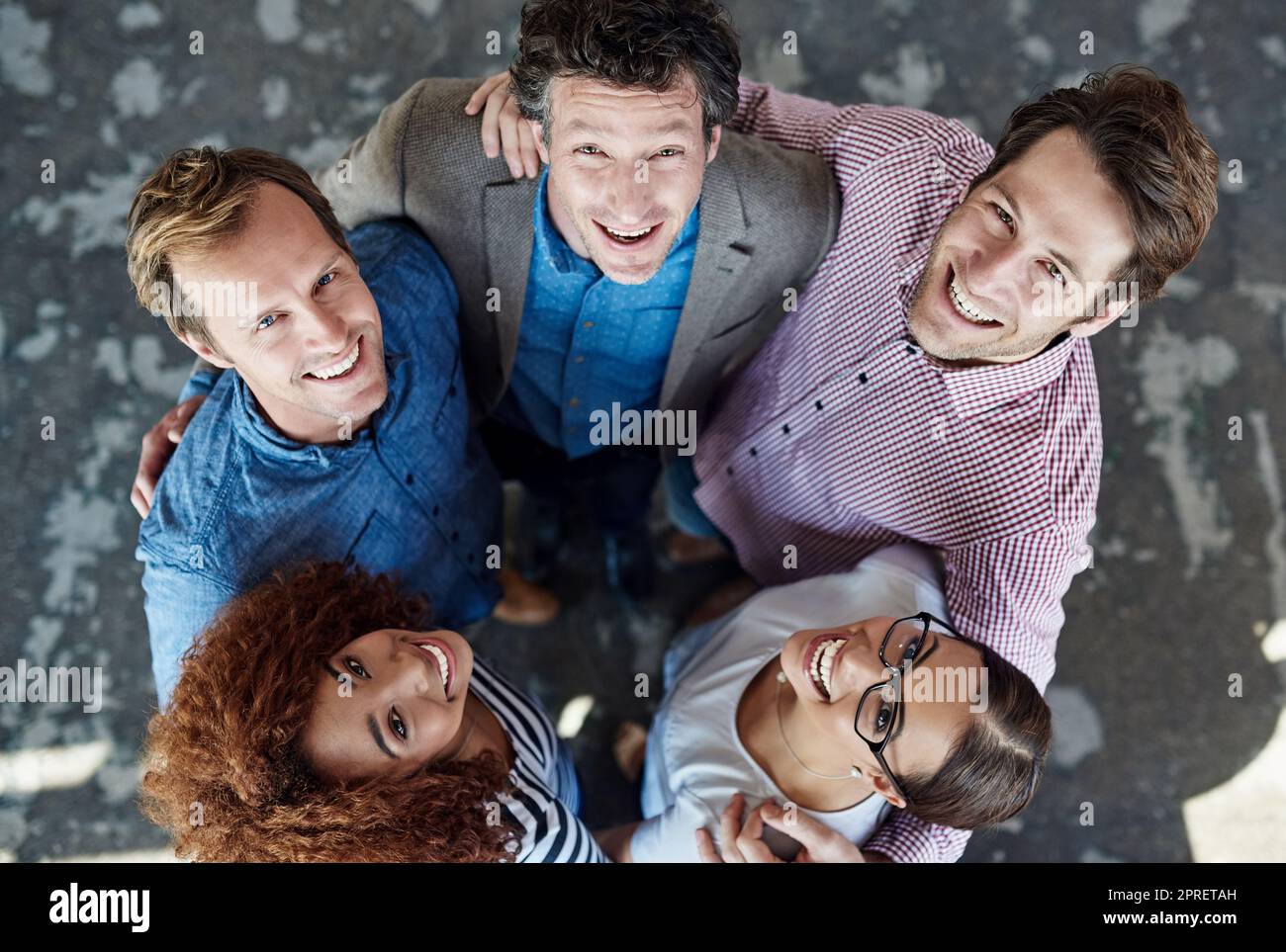 Cheerful, united and diverse group of young business colleagues in ...