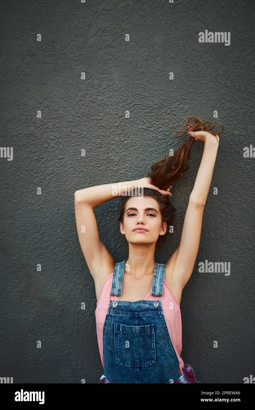 Lean back and take it easy. Portrait of a carefree young woman holding ...