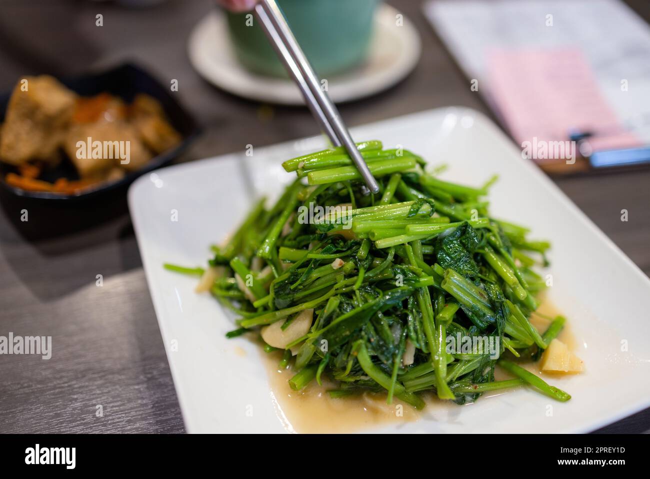 Fry water spinach dish in restaurant Stock Photo - Alamy