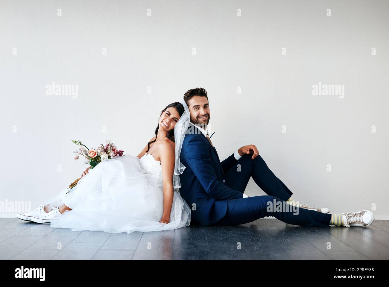 We are a perfect match. Studio shot of a newly married young couple ...