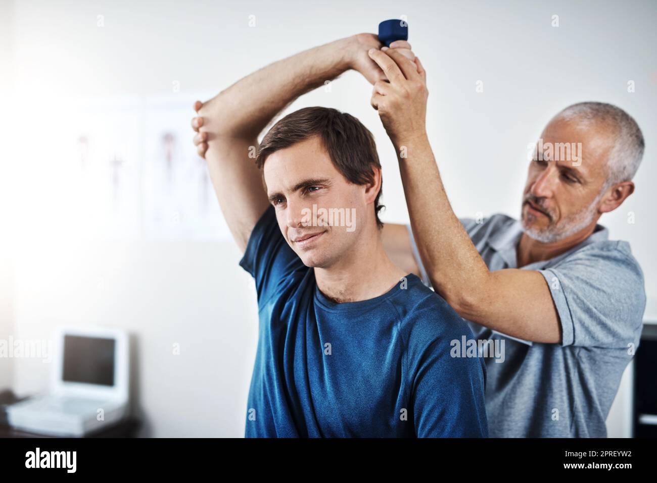 Improving his range of motion through physiotherapy. a physiotherapist ...