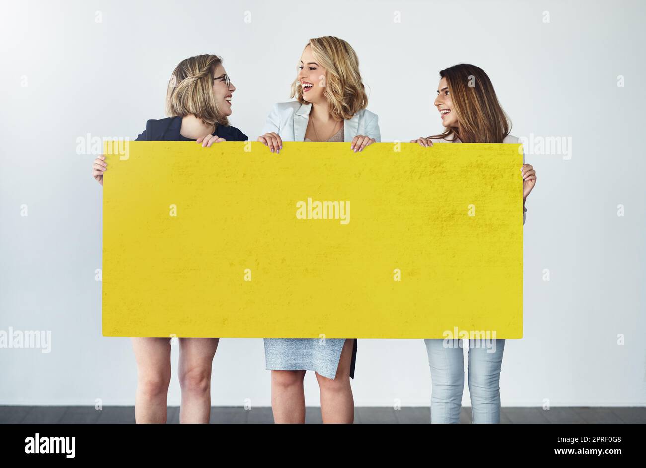 Yellow, the color of happiness. Studio shot of a group of businesswomen ...