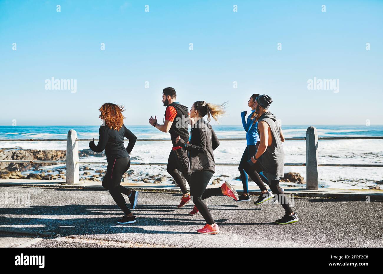 Friends offer encouragement to keep you going. a fitness group out running on the promenade ...