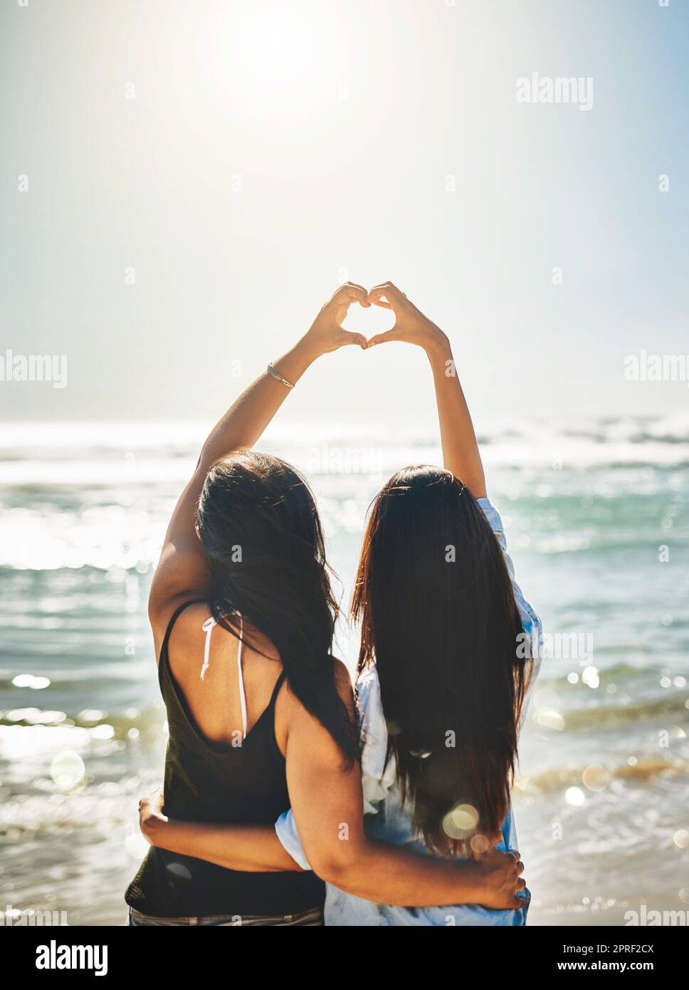 Two Best Friends Holding Hands On The Beach