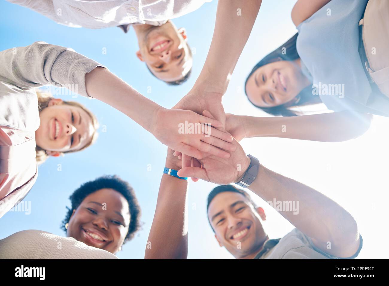 Group of friends hands stacked in success and unity from below for teamwork, collaboration and ...
