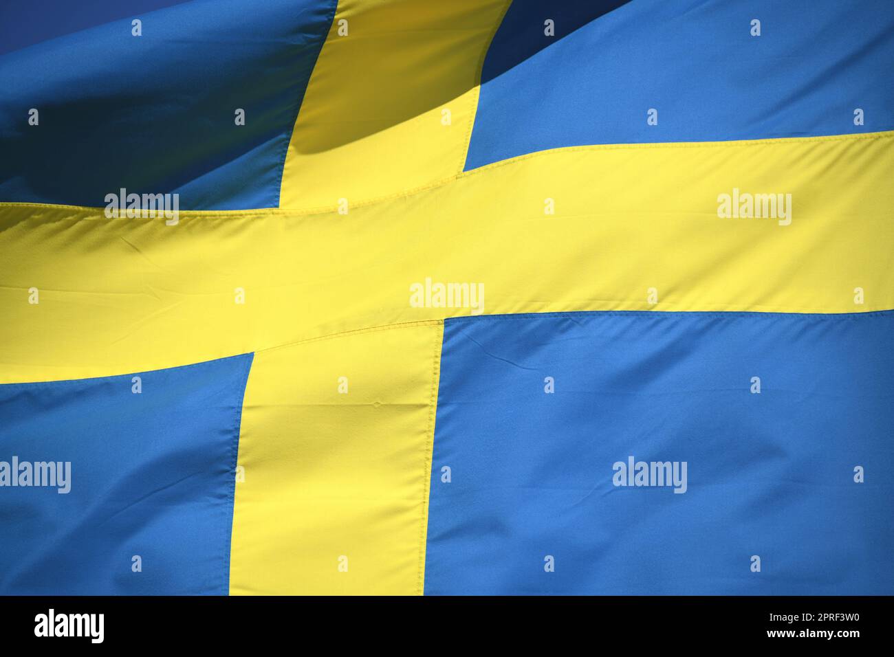 The national flag of Sweden in the colors blue and yellow is waving in ...