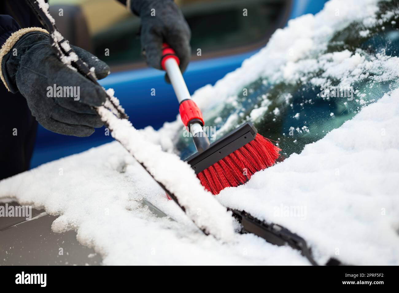 Man brushing snow hi-res stock photography and images - Alamy